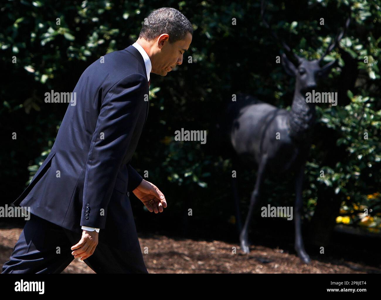 President Barack Obama walks back to the Oval Office after saying ...
