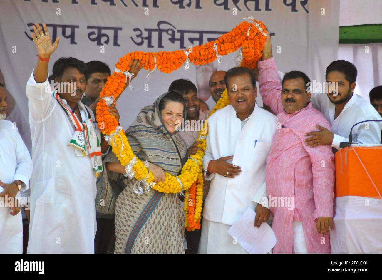 Congress party President Sonia Gandhi, center wearing sari, is offered ...