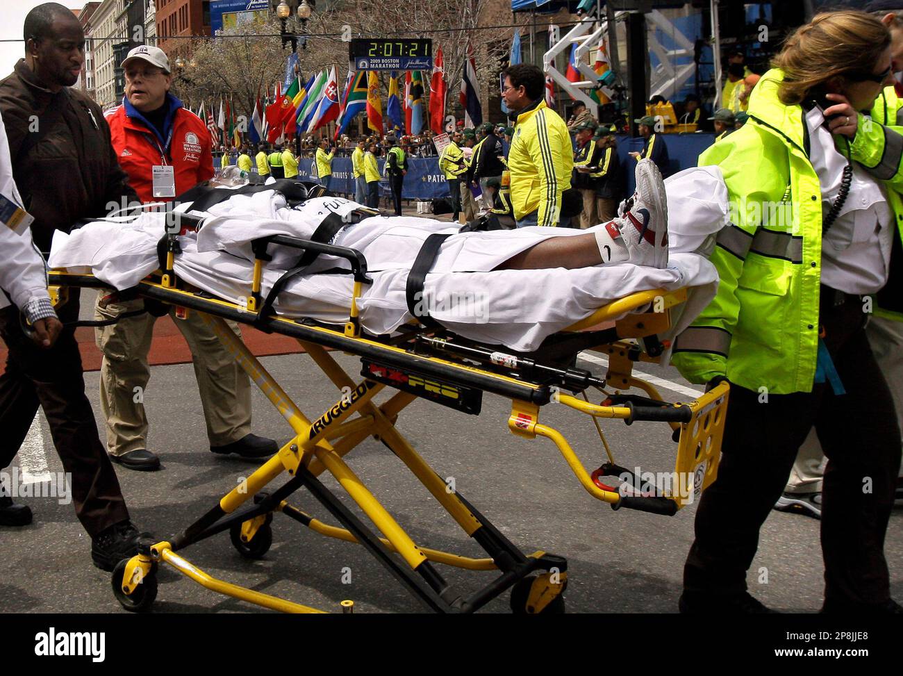 Second placed woman runner, Dire Tune, of Ethiopia, is wheeled away in ...