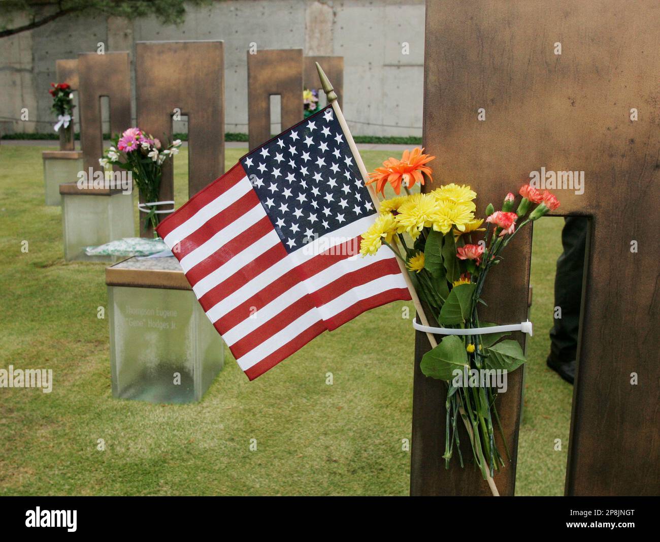 A flag and flowers mark the chair of Captain Randolph A. Guzman in the ...