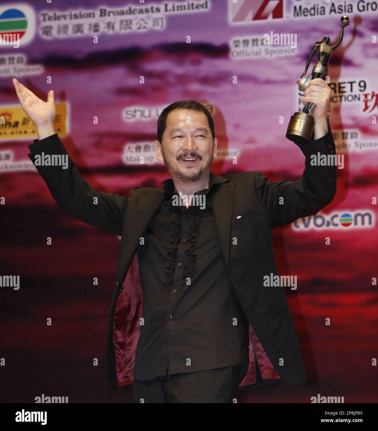 Hong Kong actor Liu Kai Chi celebrates with the trophy after winning ...