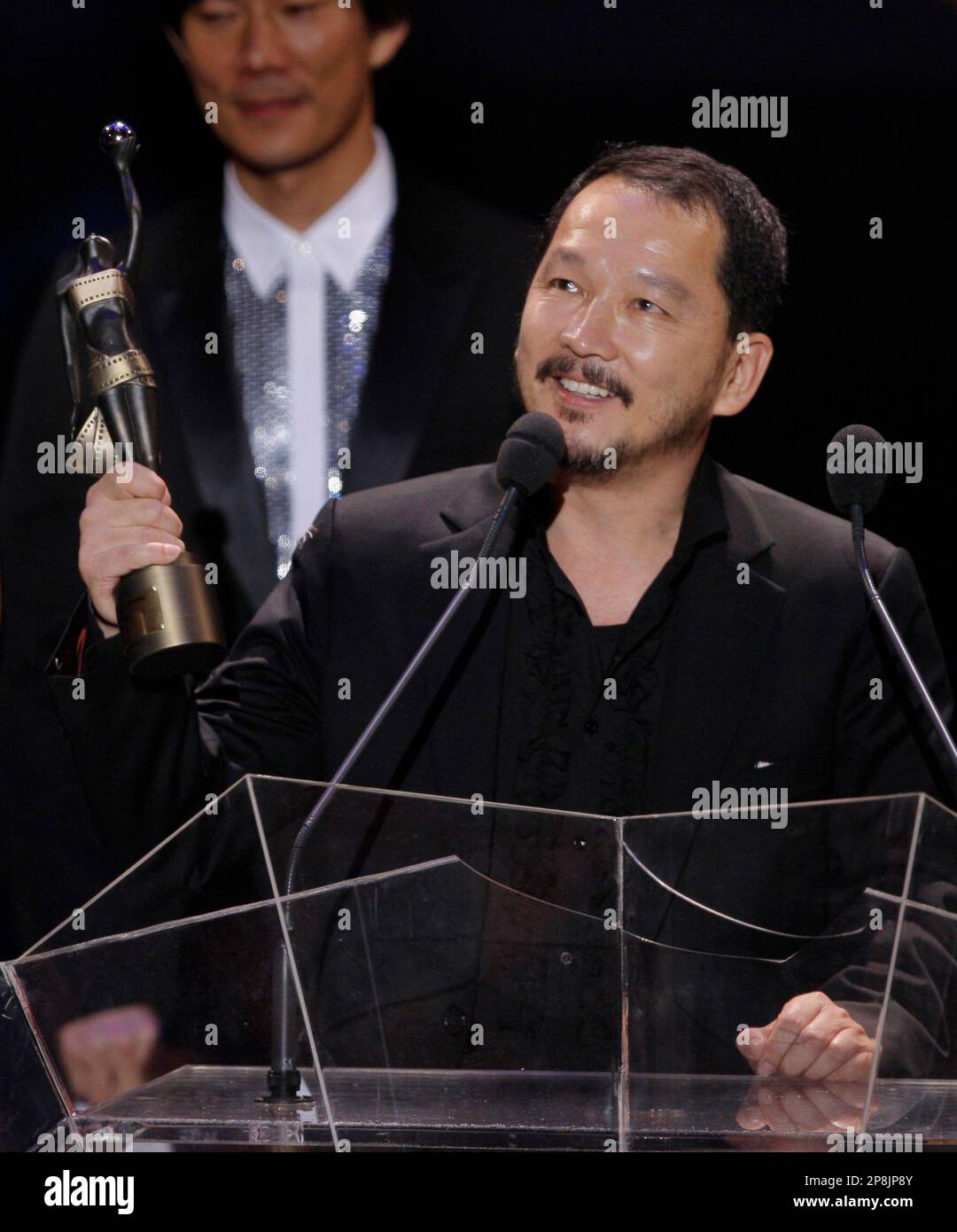 Hong Kong's actor Liu Kai Chi celebrates with the trophy after winning ...