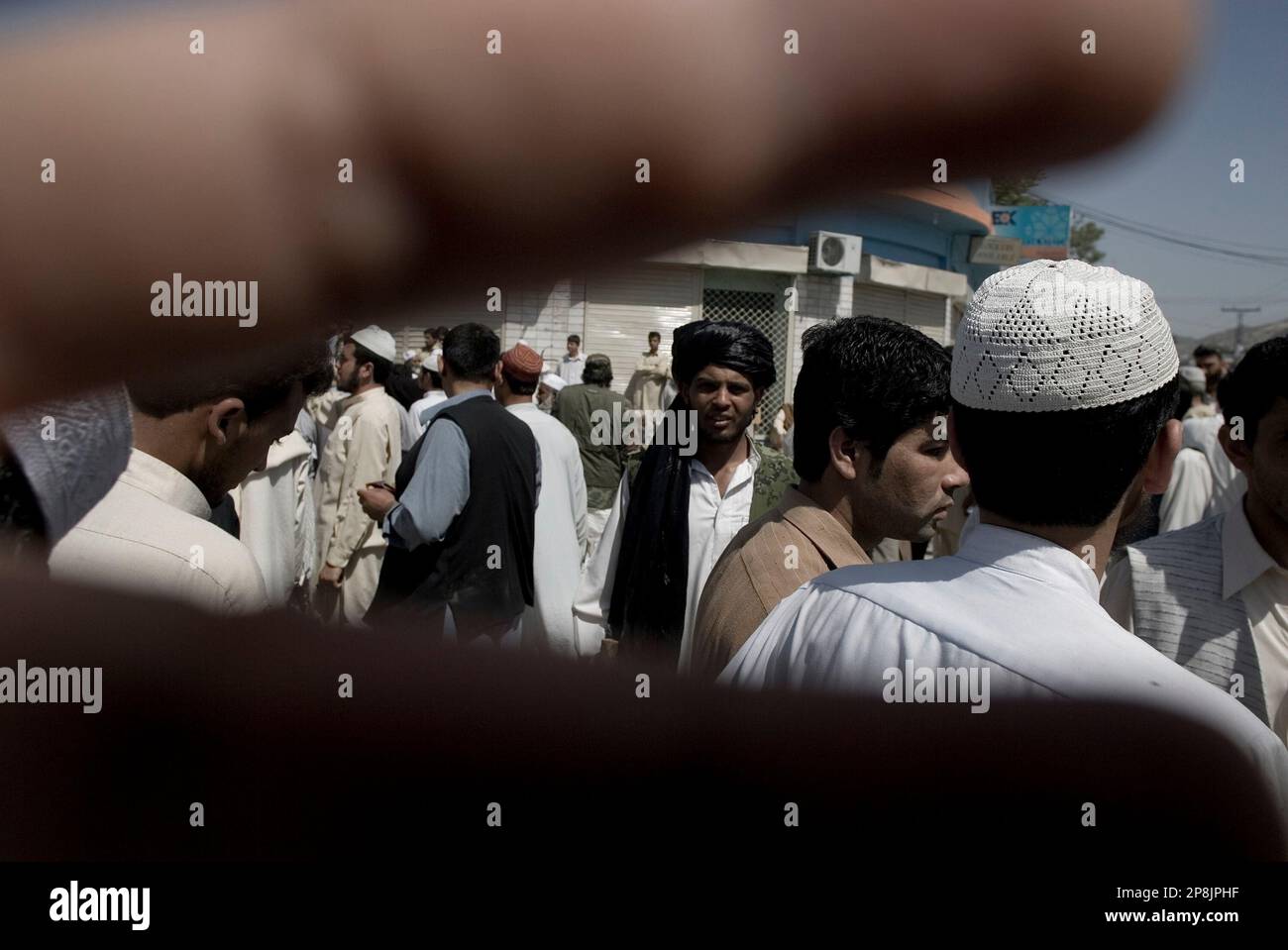 A Pakistani Taliban blocks a camera to avoid their pictures in Mingora ...
