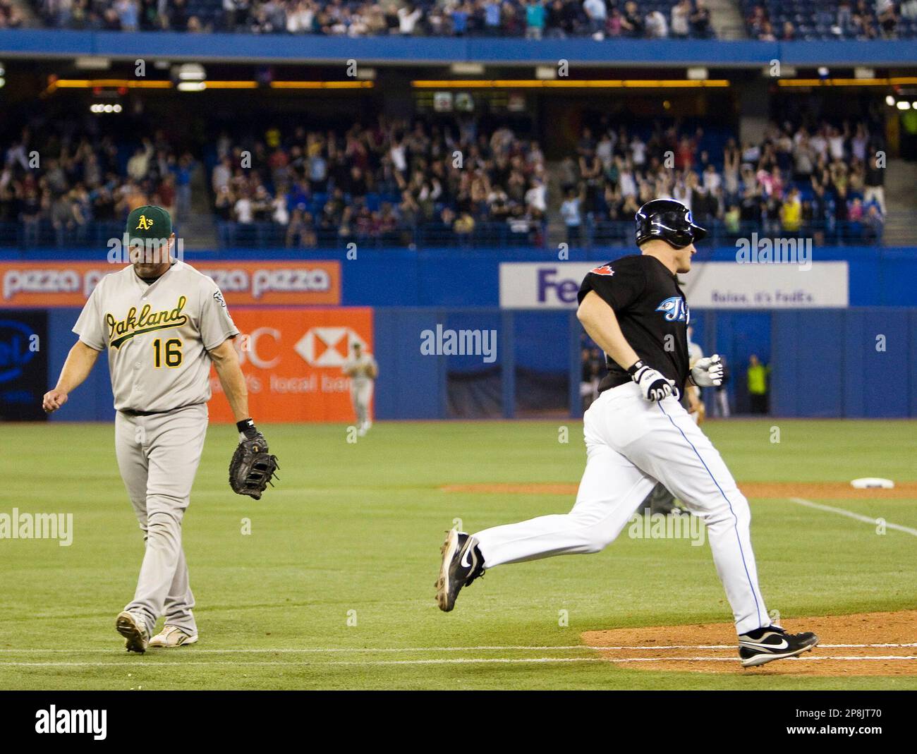 Toronto Blue Jays first baseman Lyle Overbay, right, rounds the bases ...