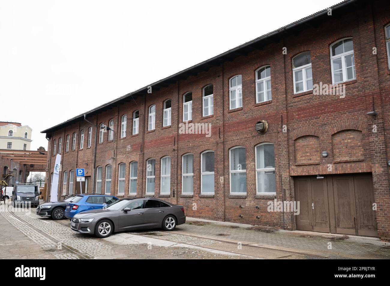 09 March 2023, Saxony, Görlitz: Cars are parked in front of the future ...