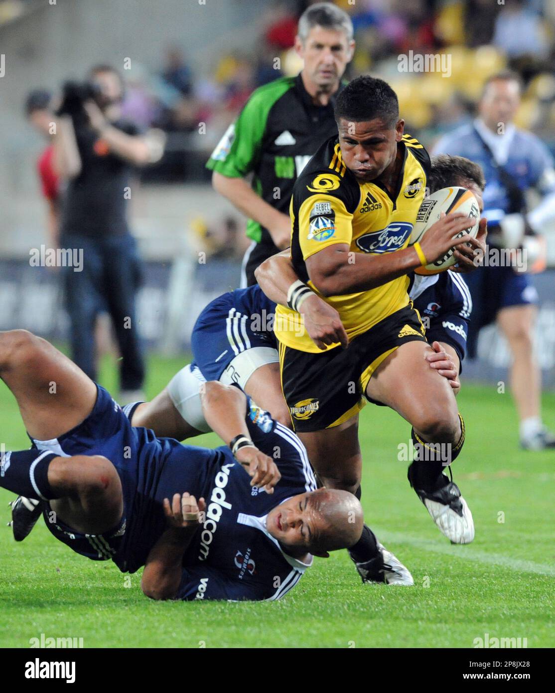New Zealand Hurricanes' David Smith, right, slips the tackle of South ...