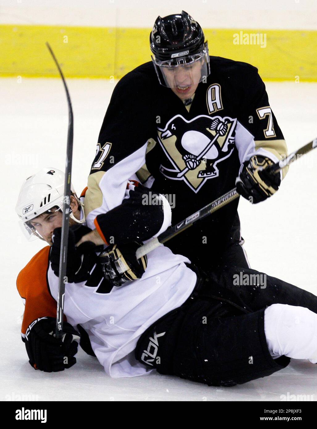 Pittsburgh Penguins' Evgeni Malkin, top, of Russia, gets tangled with ...