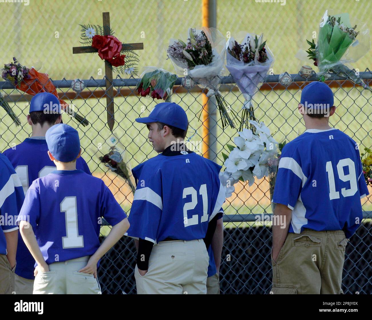 Members of the Williamsport High School baseball team look at a ...