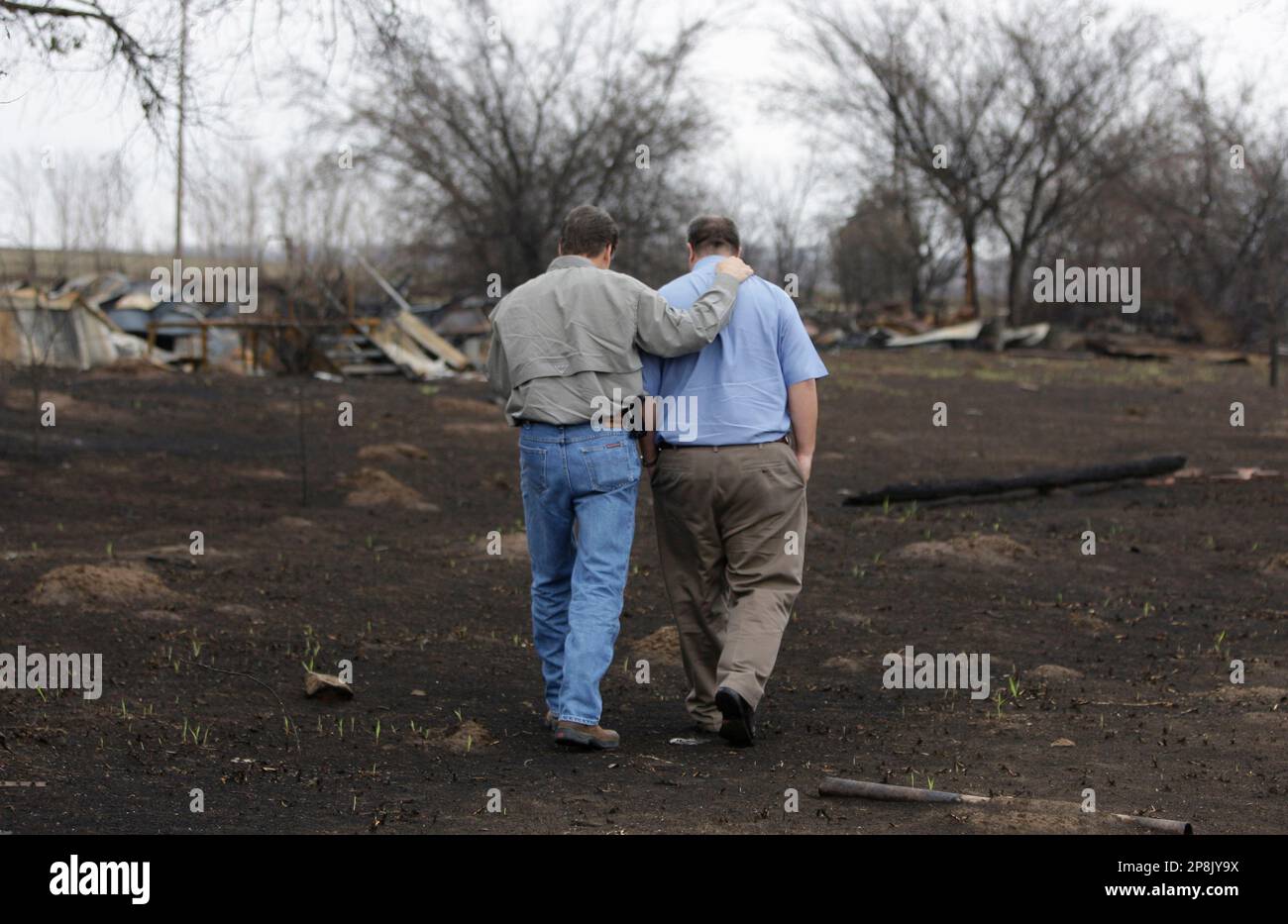 Texas Gov. Rick Perry, left, puts his arm around Montague County Judge ...