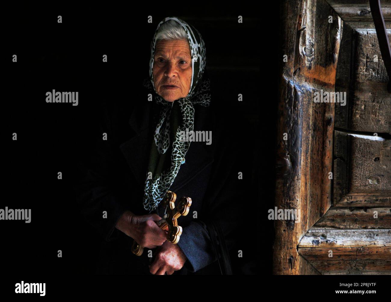 A Christian Orthodox pilgrim clutches a cross as she stands at the ...