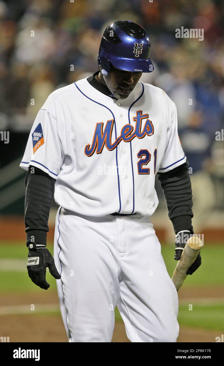 New York Mets' Carlos Delgado leaves the field after striking out for ...