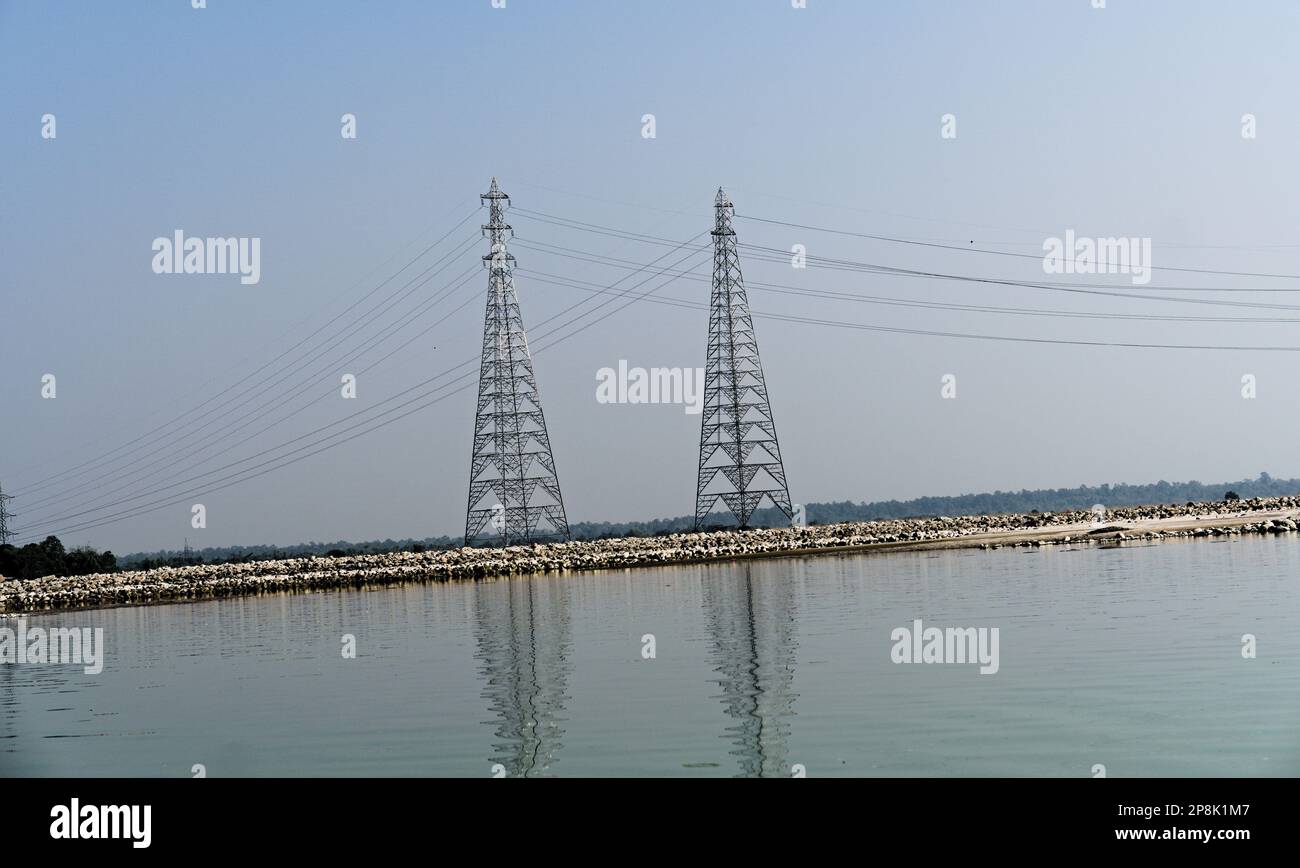 pair of metal towers for power supply on river Stock Photo - Alamy