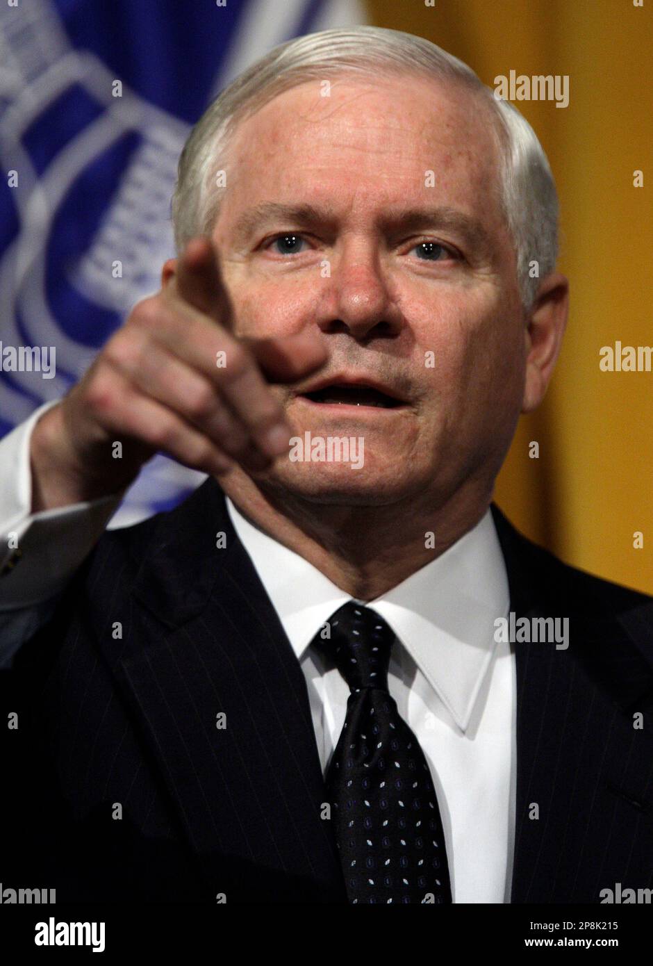 Defense Secretary Robert Gates points to the audience while speaking to ...