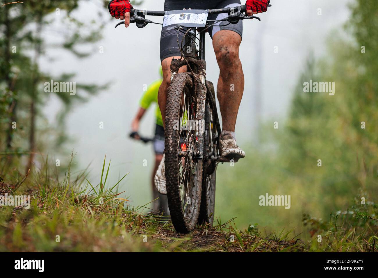 Cross country cyclist riding in mud hi-res stock photography and images ...