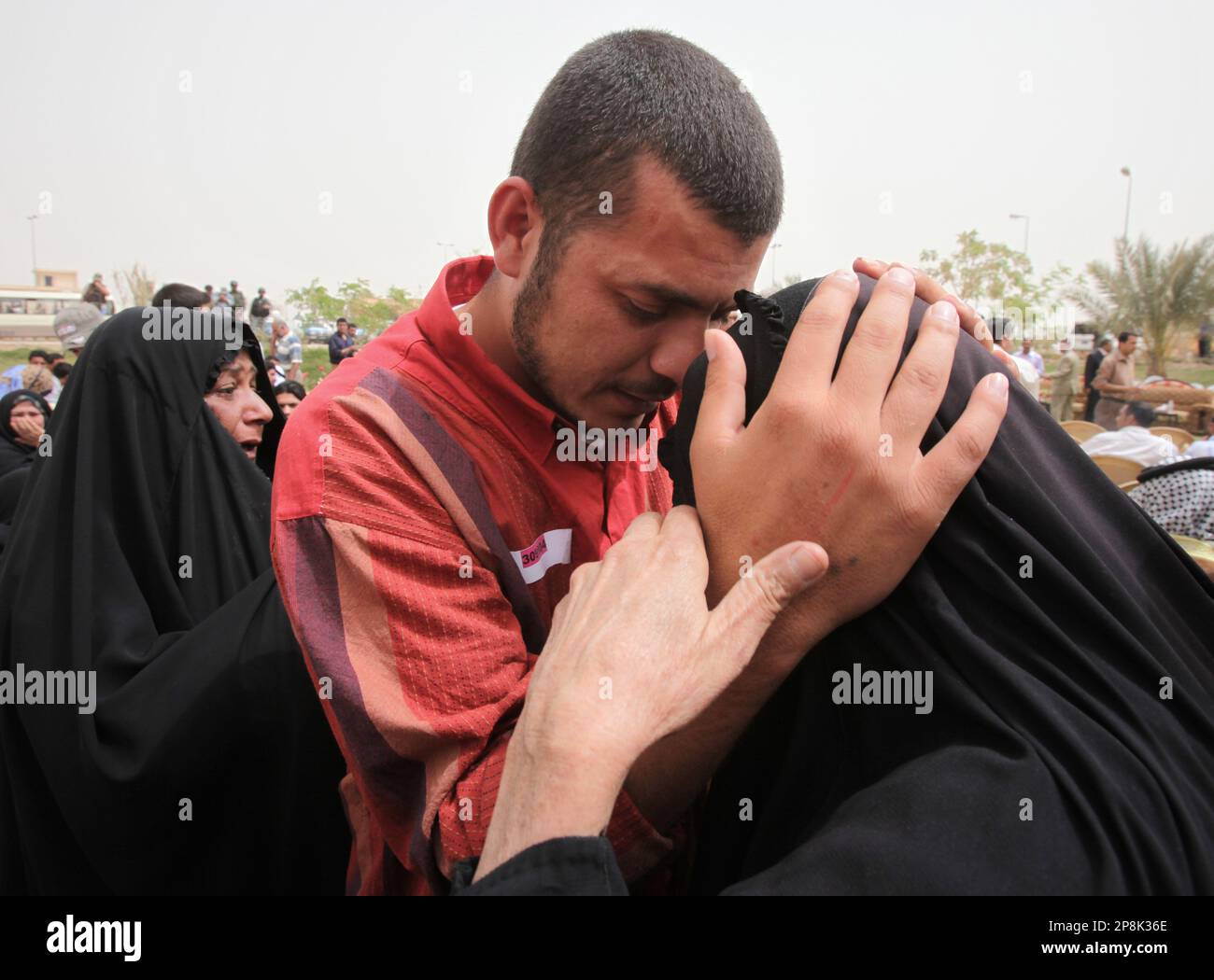 An Iraqi man embraces a relative after his release from U.S. military ...