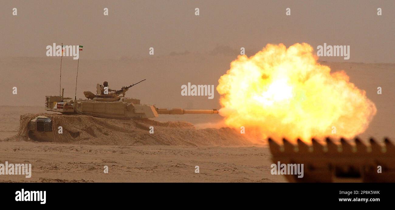 A US-made M1A1 Kuwait Army tank fires on a target during a military ...