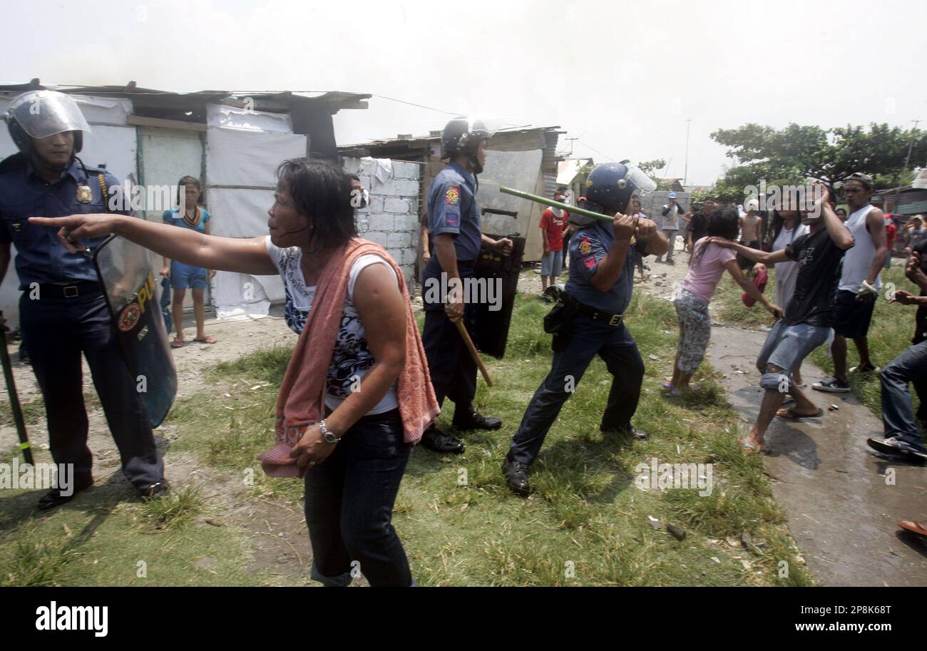 Residents fight with police as the latter and demolition crew (unseen ...