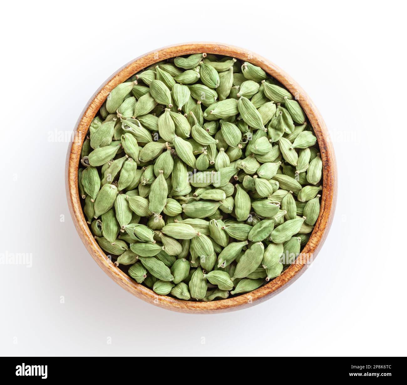 Cardamon pods in wooden bowl isolated on white background with clipping ...