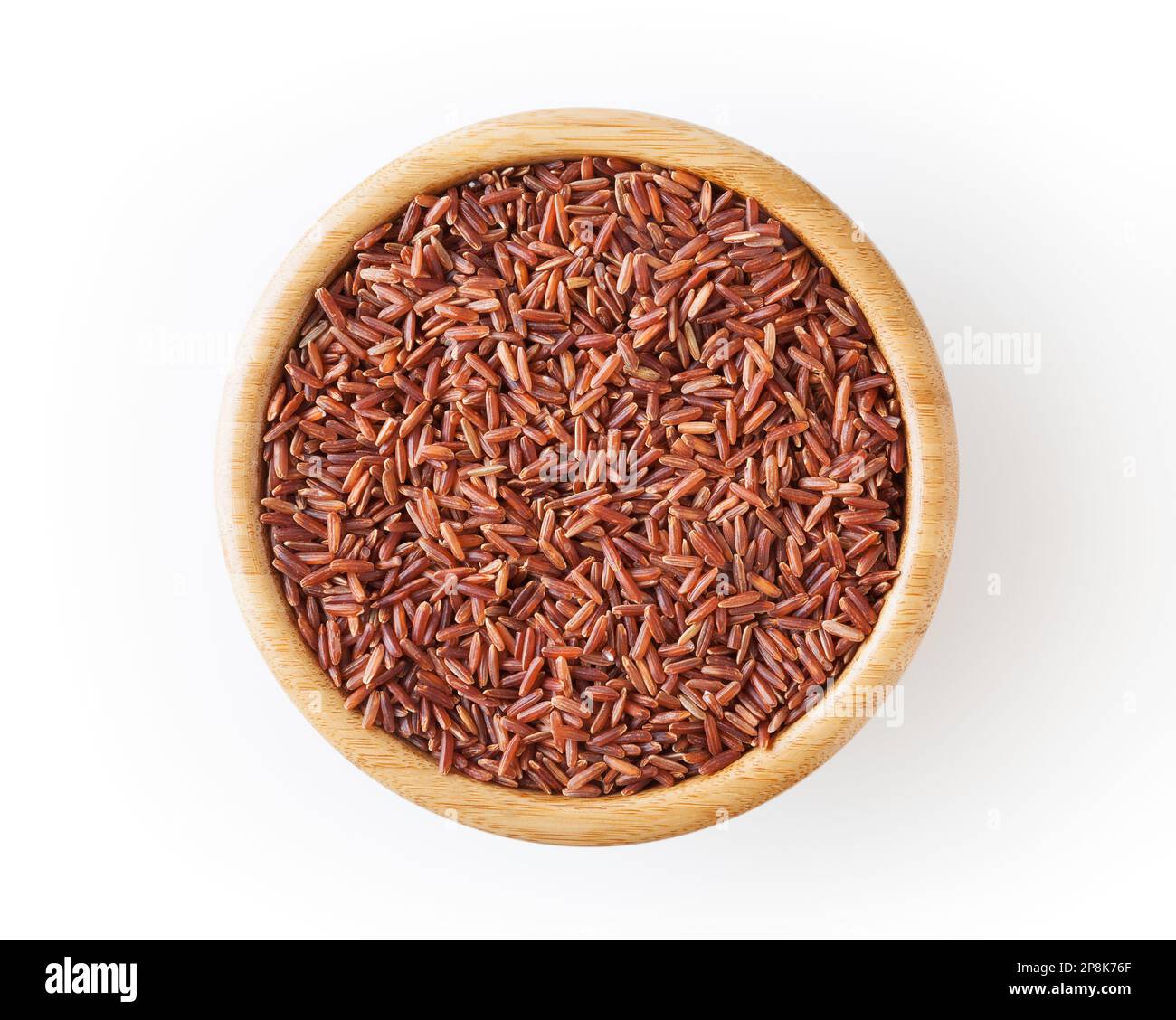 Uncooked red rice in wooden bowl isolated on white background with ...