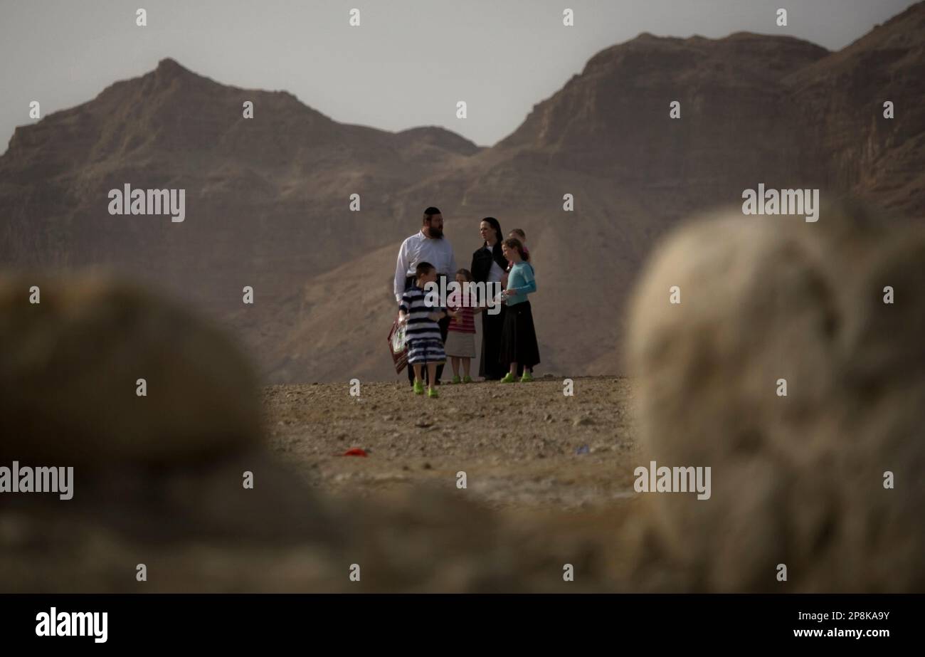An Orthodox Jewish family walks to the Dead Sea shore during the Jewish ...