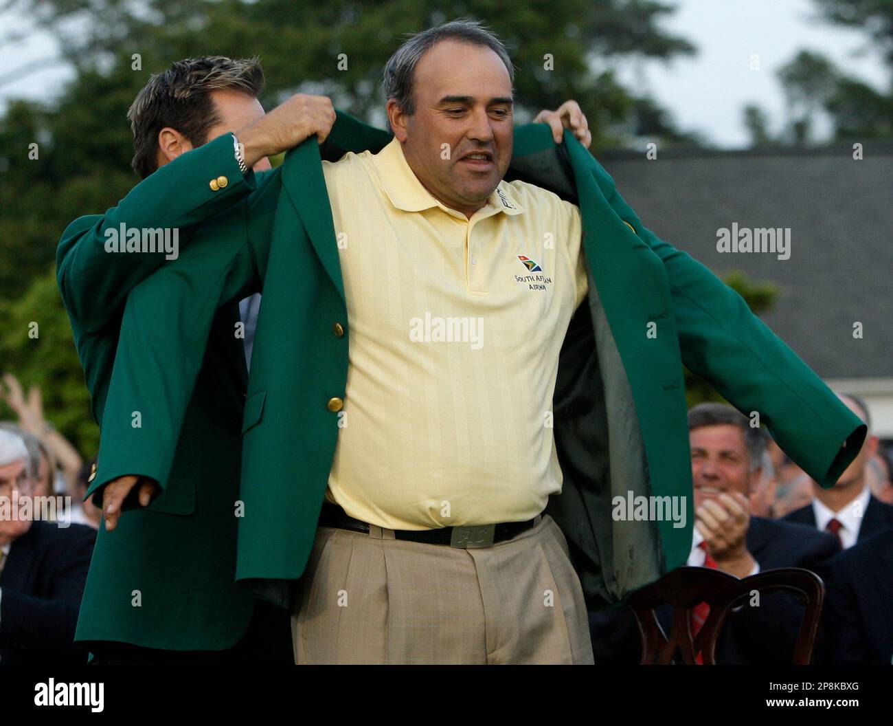 Former Masters' champion Trevor Immelman of South Africa helps 2009 ...