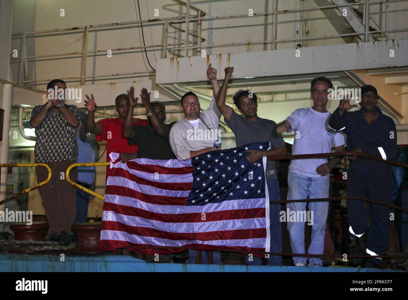 Crew members celebrate on the deck of the Maersk Alabama after their ...