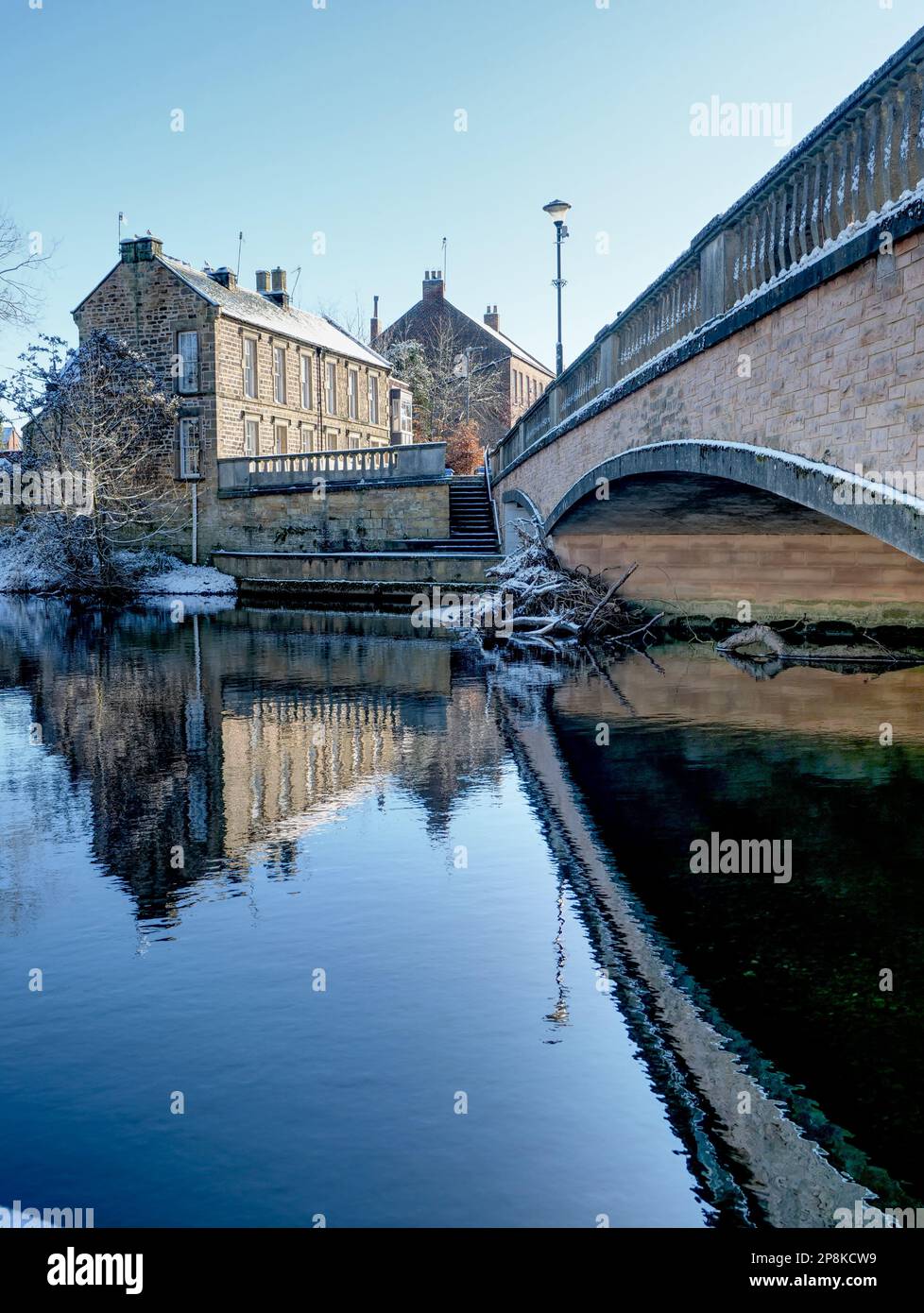A snowy winter view of Oldgate bridge spanning the River Wansbeck in ...