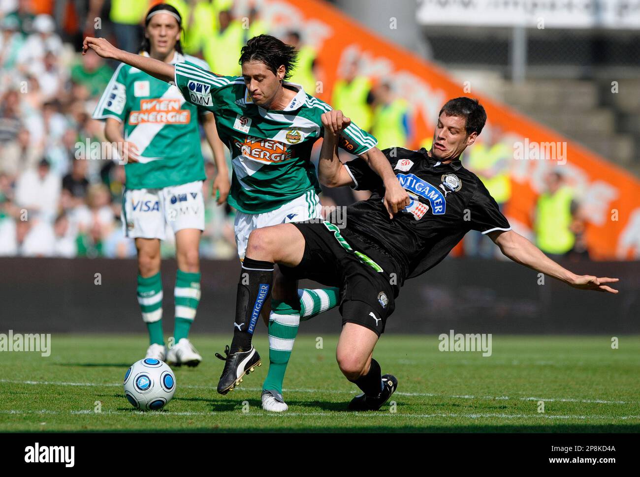 Rapid's Branko Boskovic, left; and Sturm's Dominik Hassler challenge ...