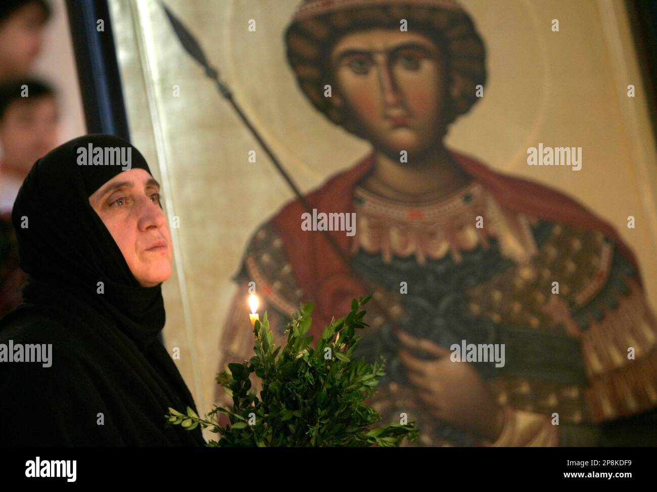 A Georgian nun attends a religious service during Palm Sunday ...