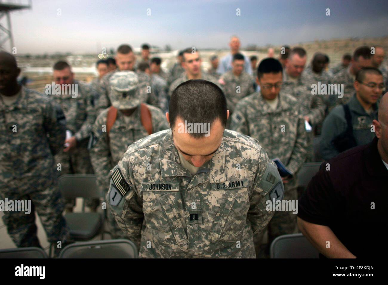 U.S. army soldiers bow their heads in prayer during Easter sunrise ...
