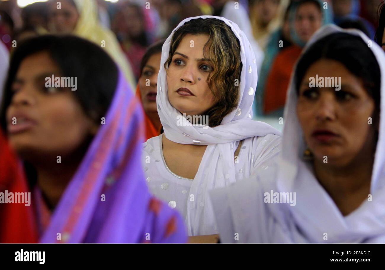 A Pakistani Christian woman listens to father during an Easter mass at ...