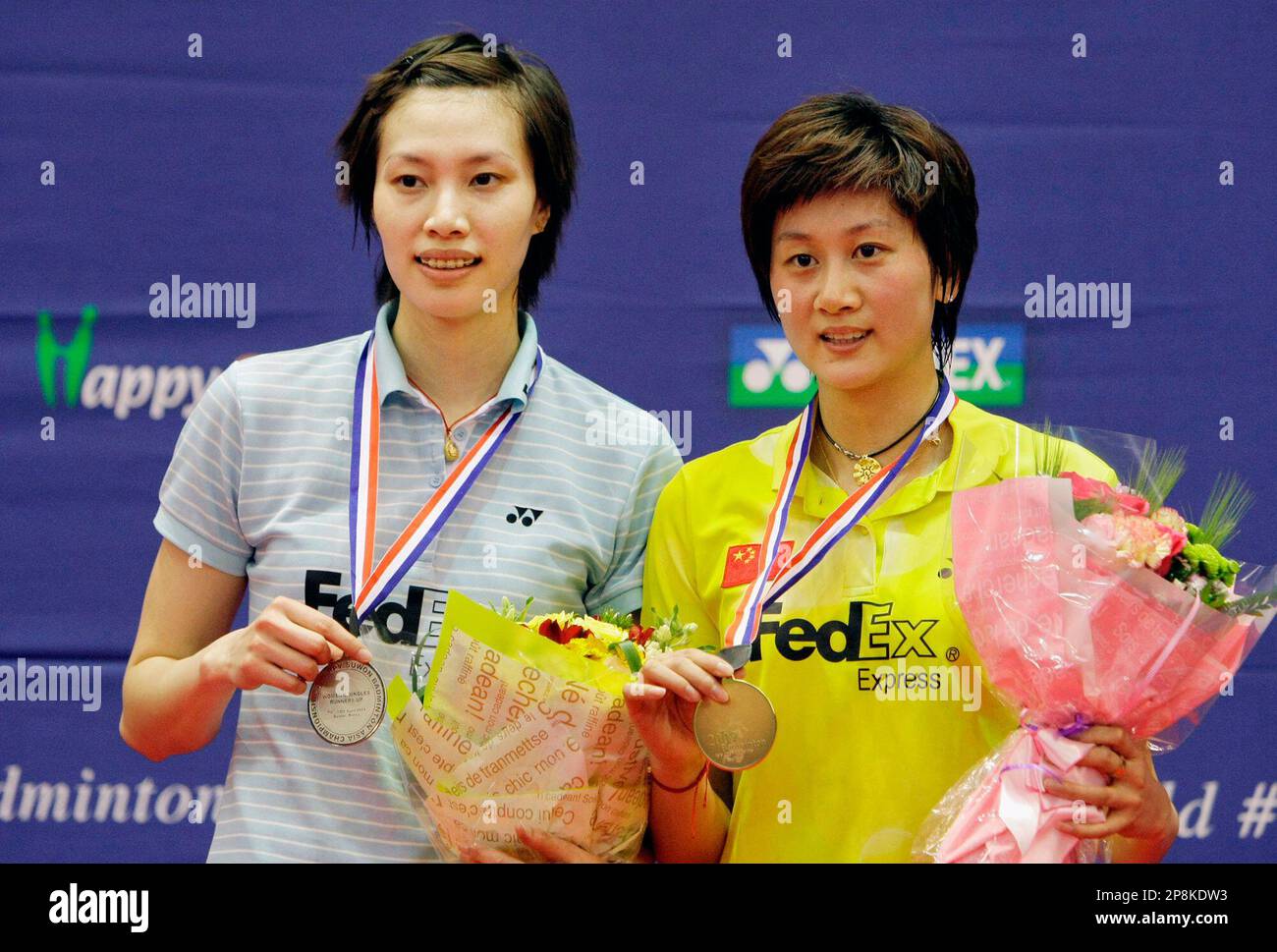 China's Zhu Lin, right, and Xie Xingfang pose after the women's single ...