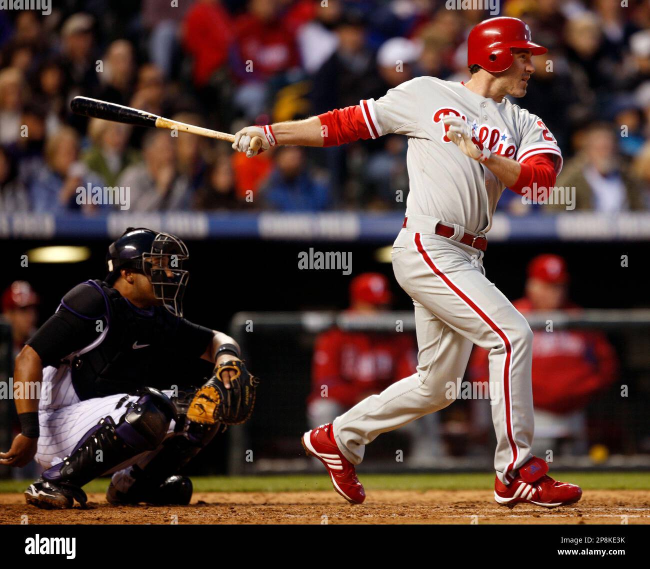 Philadelphia Phillies' Chase Utley, right, singles as Colorado Rockies ...