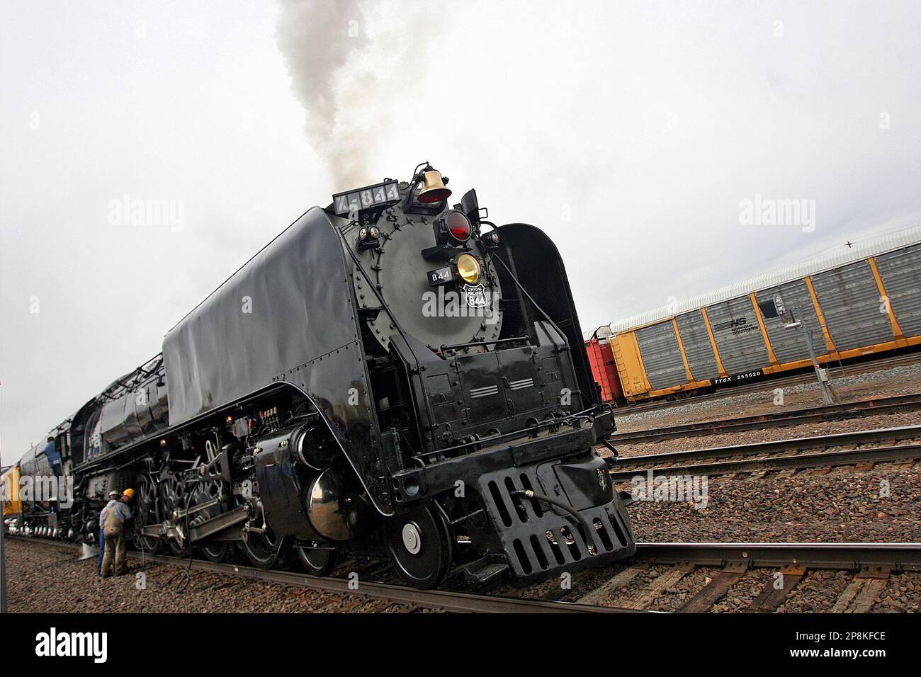 Crew members work on the Union Pacific 844 Steam Engine during a stop ...