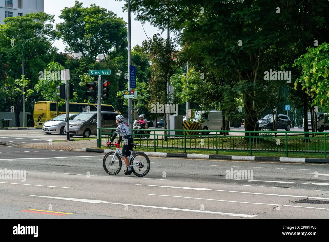 A cyclist waits at the traffic lights on Sims Ave to turn green. Sunday ...