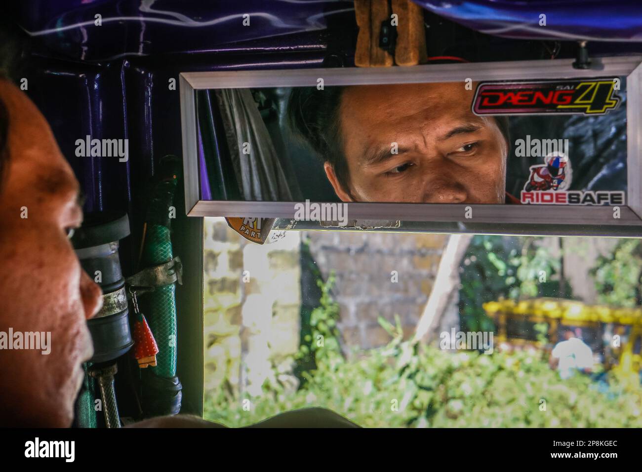 Benedict, a jeepney driver, rests inside his traditional jeepney in ...