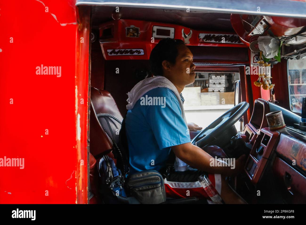 Mark, a jeepney driver, drives a traditional jeepney to transit. For ...