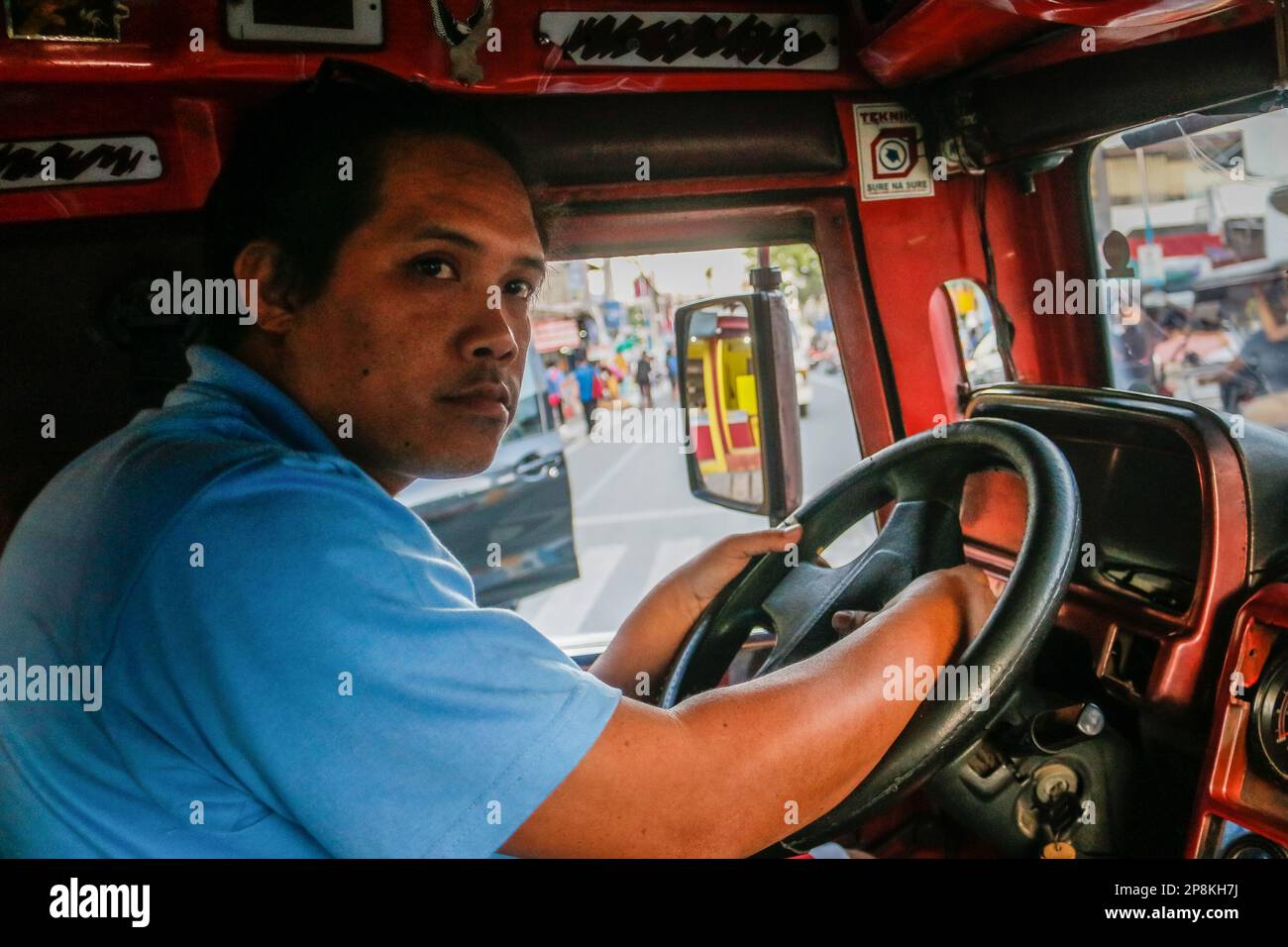 Mark, a jeepney driver, drives a traditional jeepney to transit ...