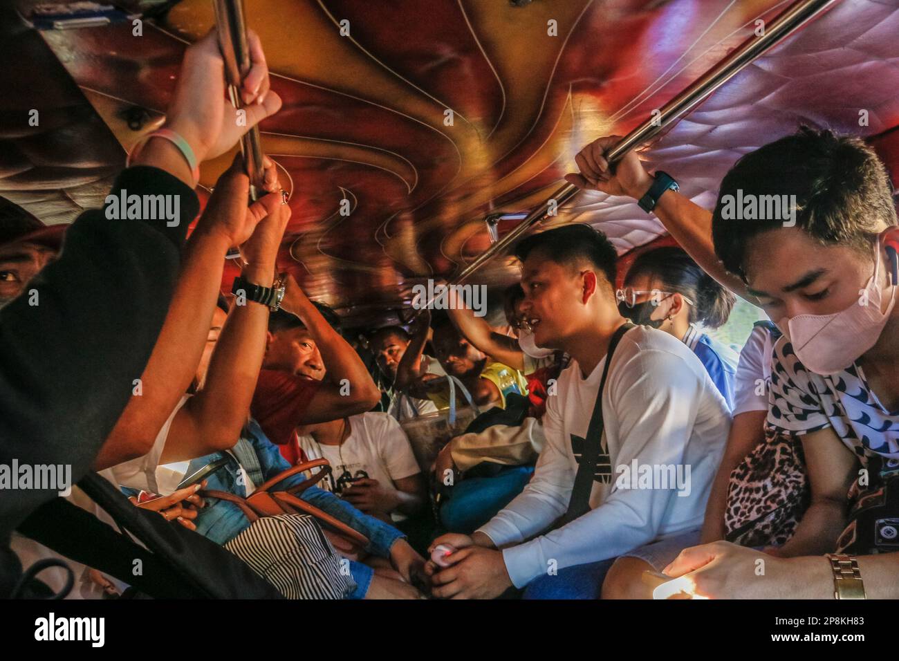 Passengers are seen seated inside of a traditional commuter's jeepney ...