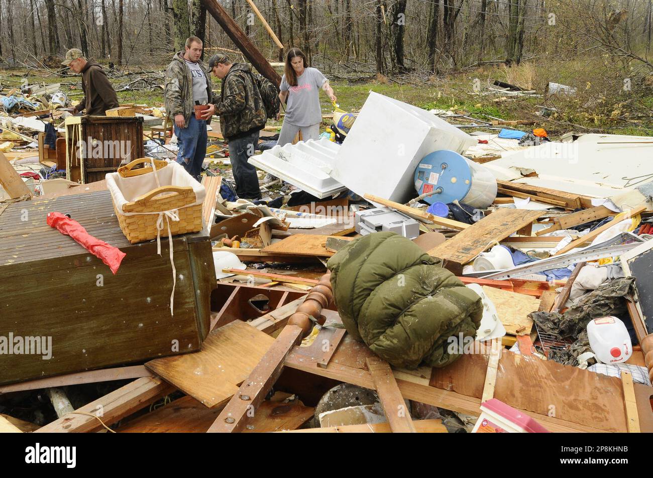 People search through the rubble of a house destroyed Friday, April 10 ...