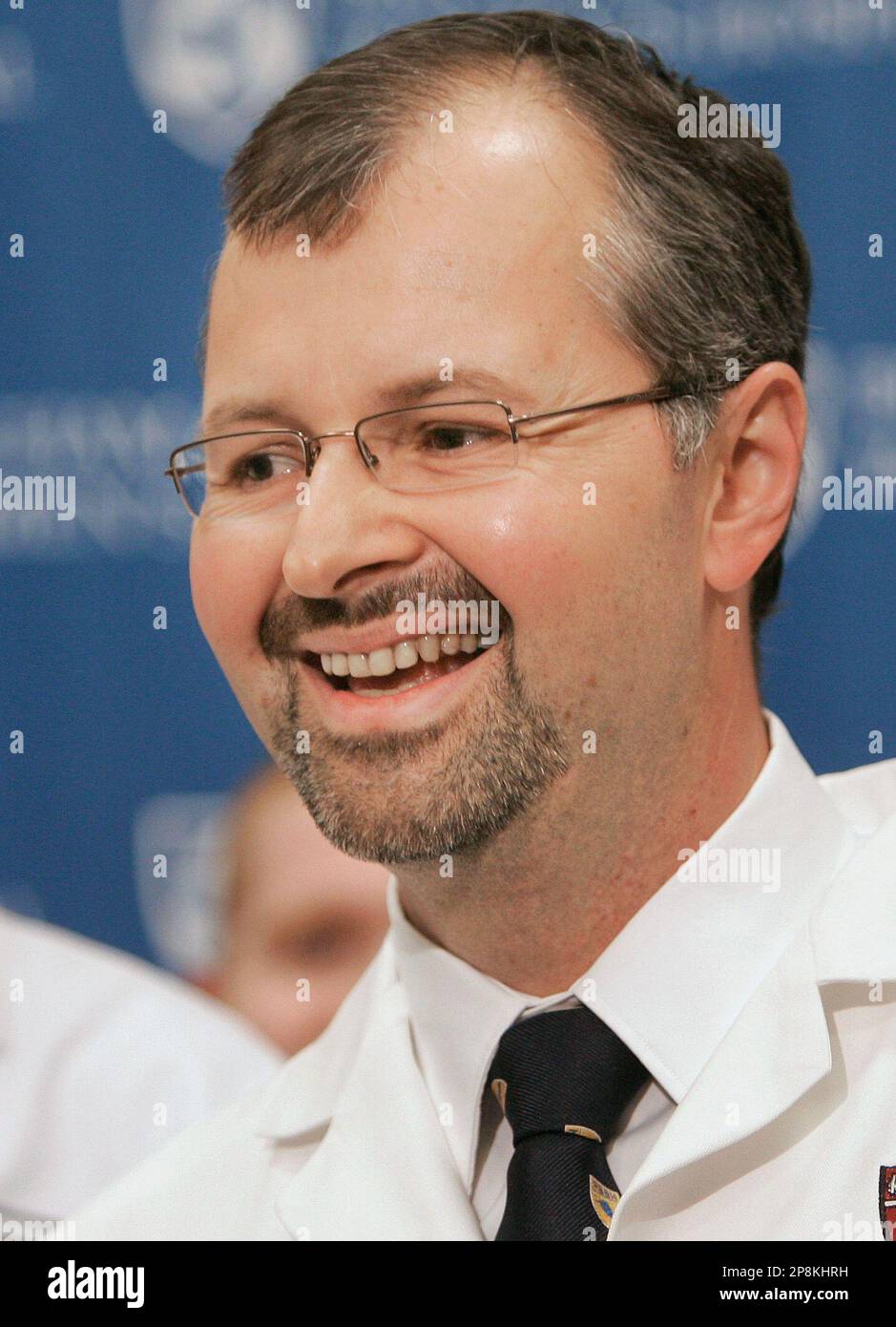 Plastic surgeon Dr. Bohdan Pomahac smiles while facing reporters during ...
