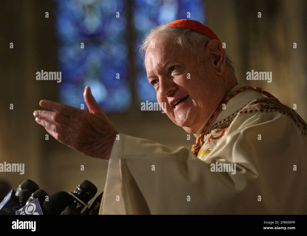 Cardinal Edward Egan responds to questions during a news interview ...
