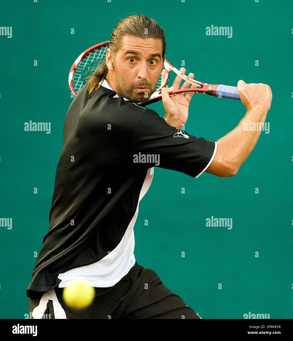 Sergio Roitman, of Argentina, keeps his eye on the ball as he prepares ...