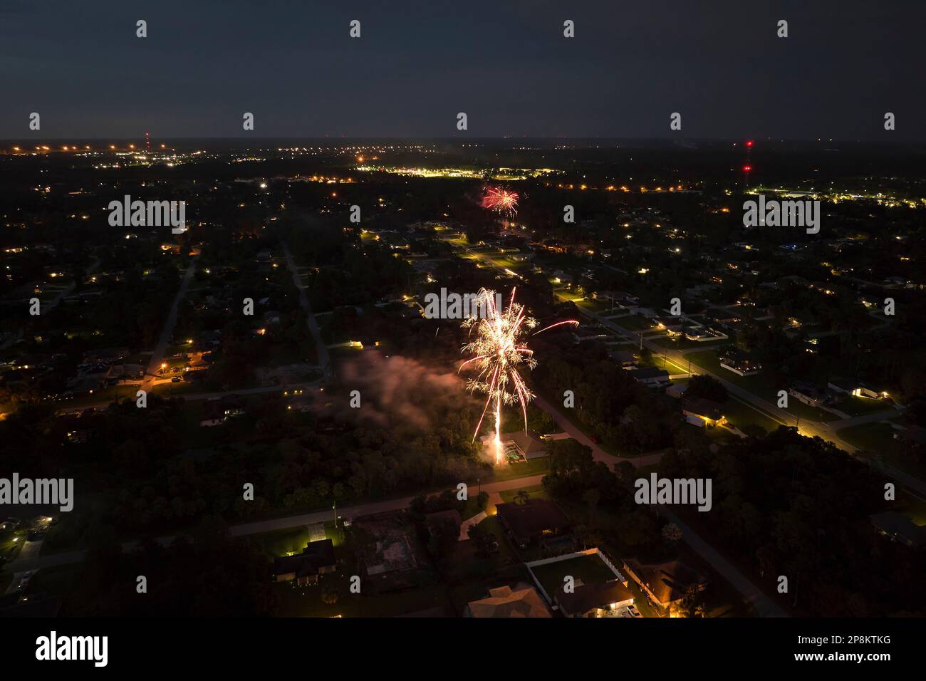 Aerial view of bright fireworks exploding with colorful lights over ...