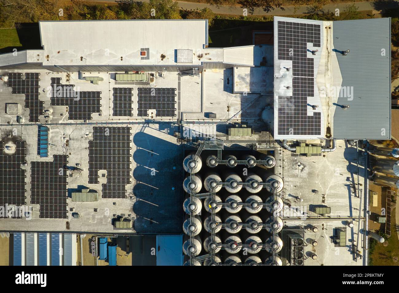Aerial view of blue photovoltaic solar panels mounted on industrial ...