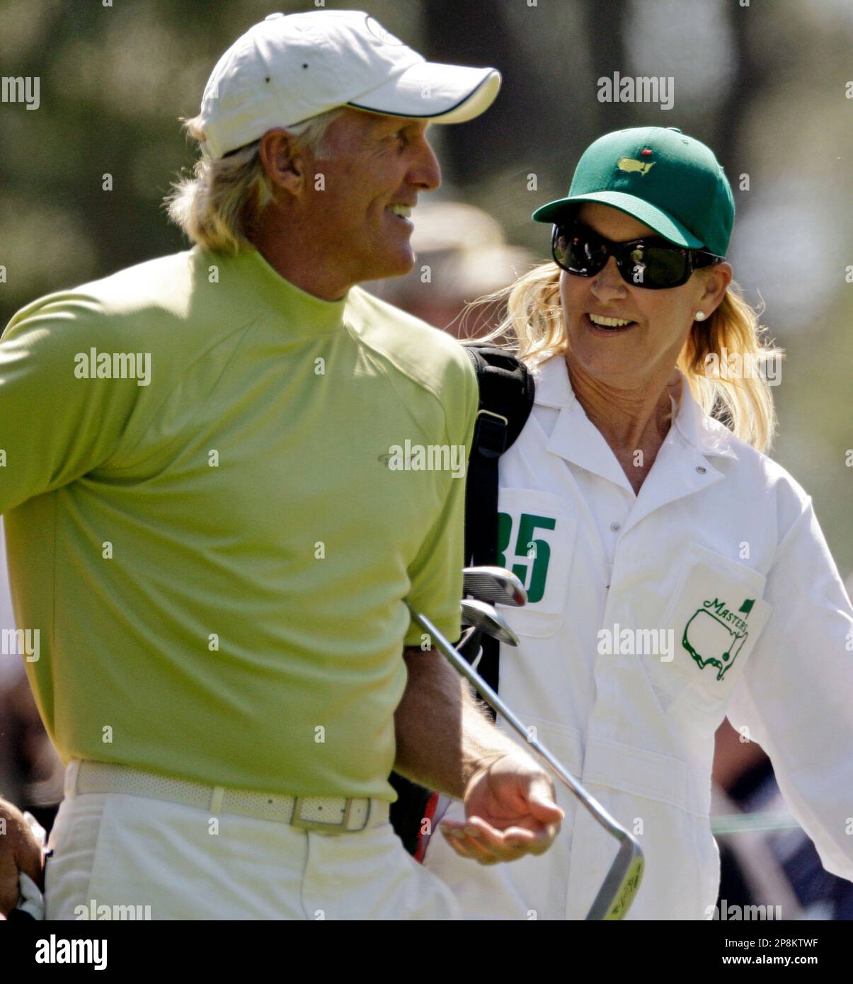 Former tennis champion Chris Evert caddies for Greg Norman of Australia ...