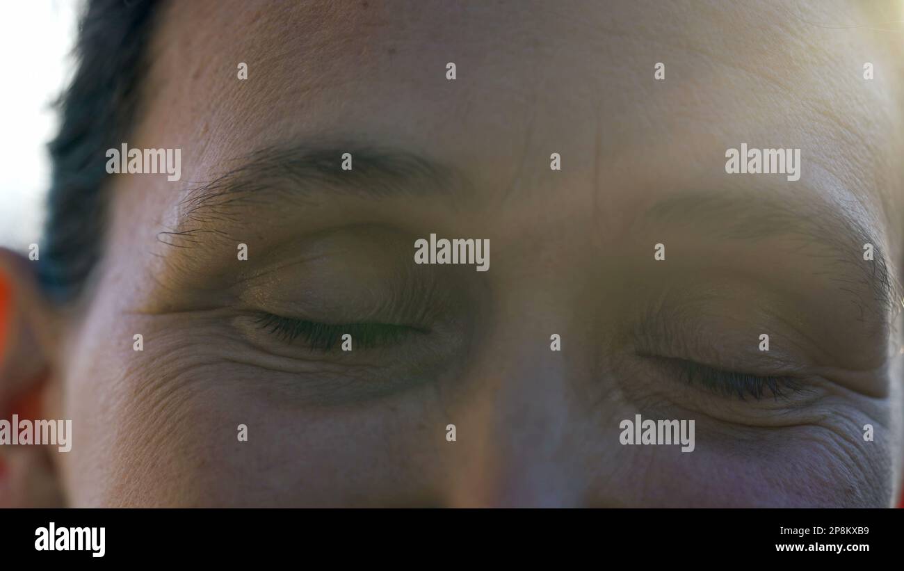 Woman closing eyes in contemplation. Macro close up of female person ...