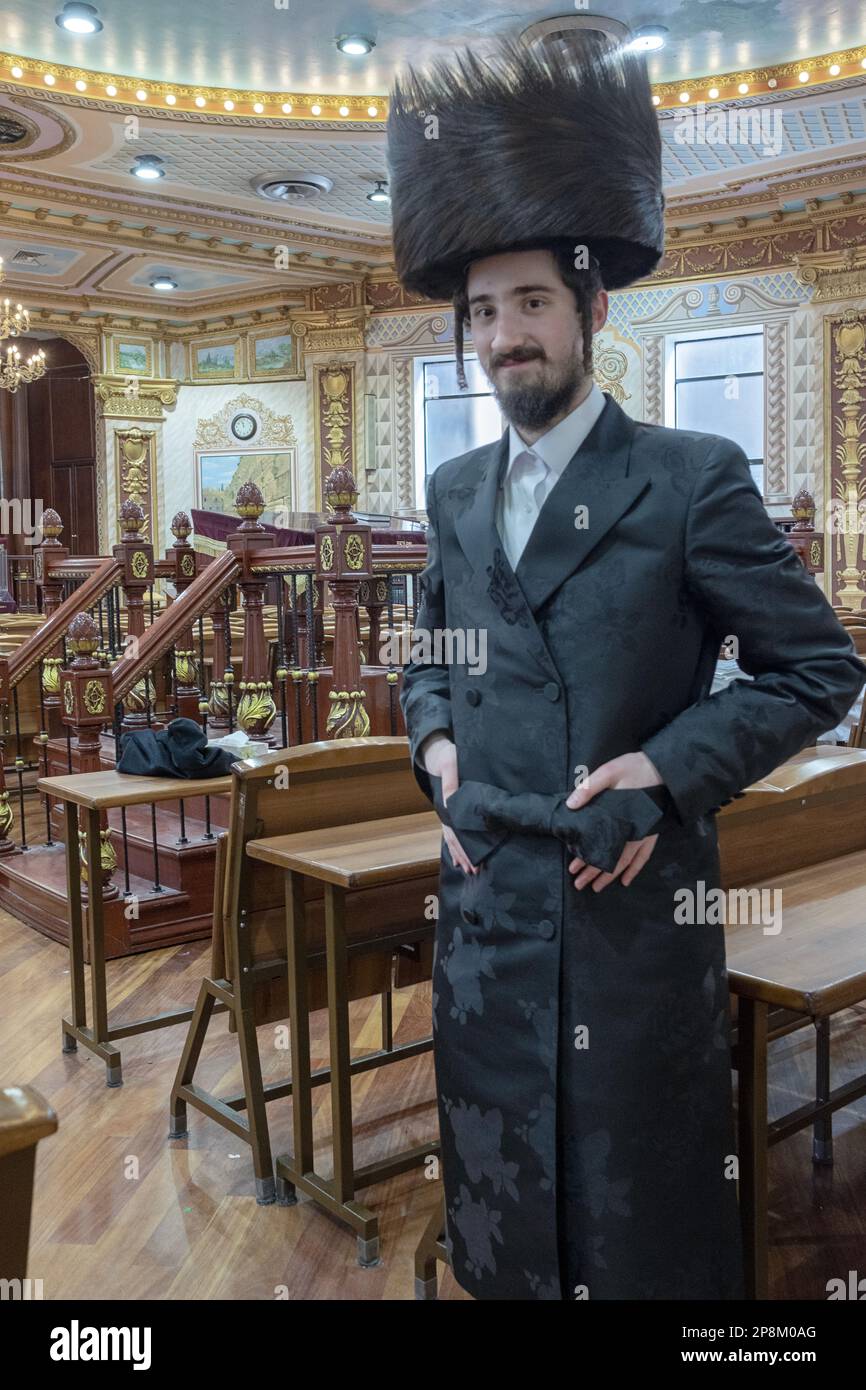 Posed portrait of a hasidic man wearing a shtreimel fur hat in an empty ...