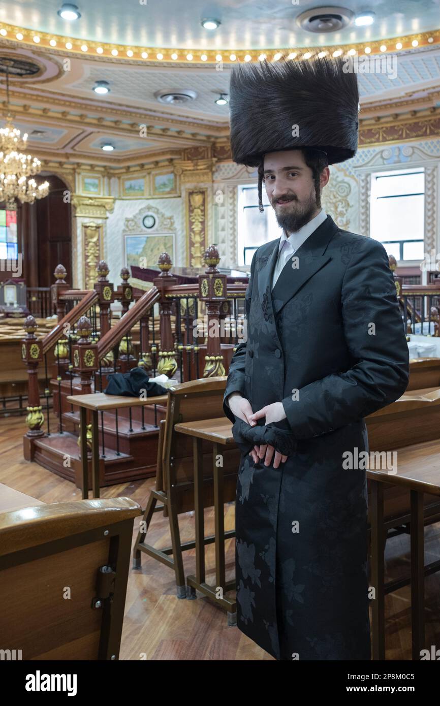 Posed Portrait Of A Hasidic Man Wearing A Shtreimel Fur Hat In An Empty Synagogue On Purim In