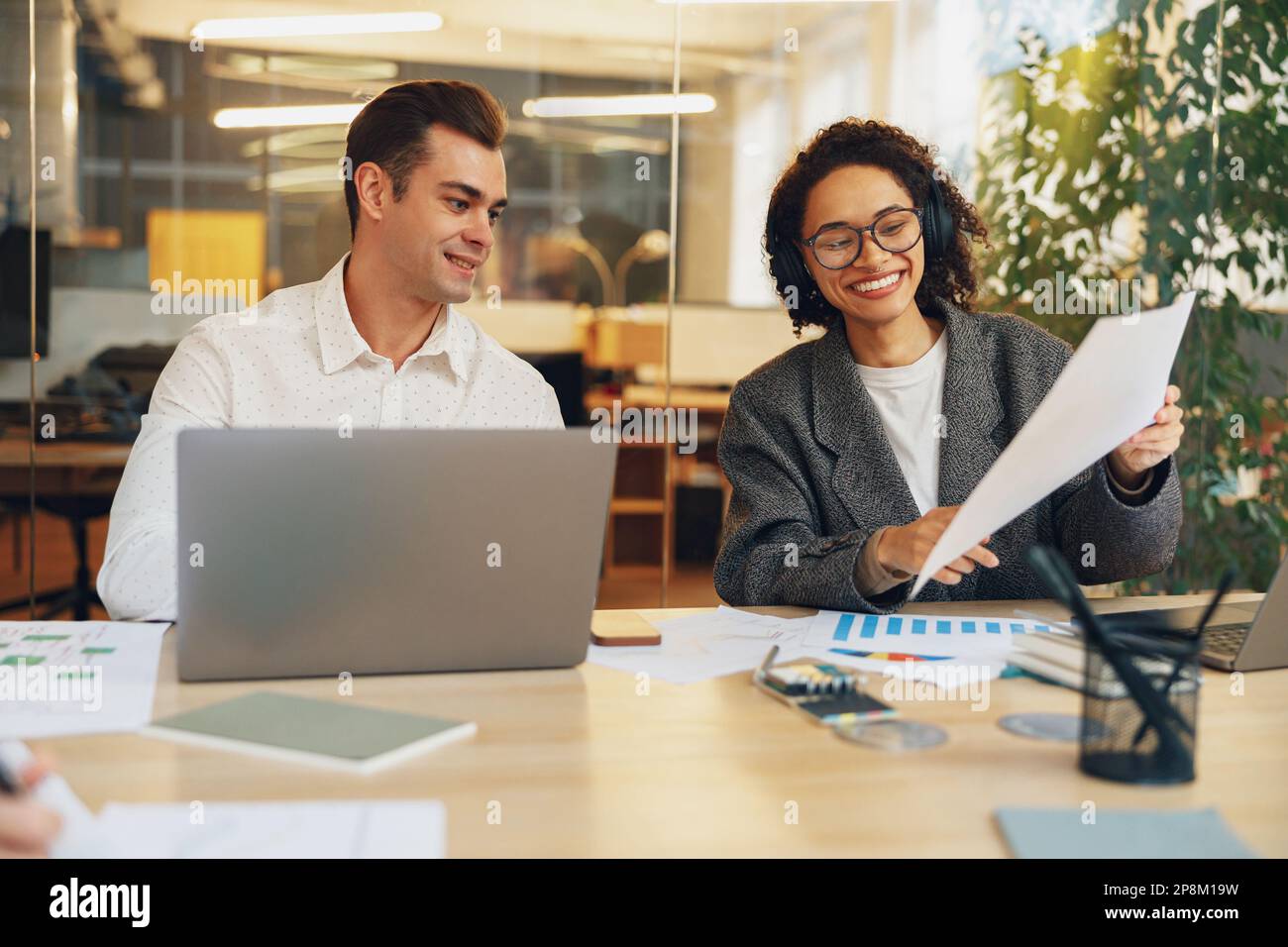 Two colleagues coworkers working together on new business plan during ...